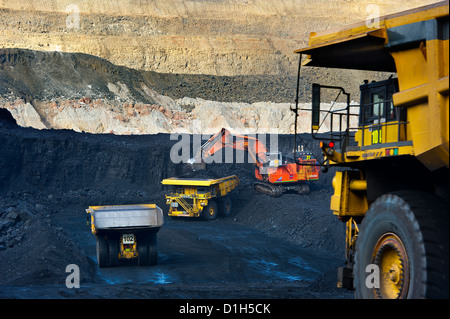 Heavy dump truck being loaded in mine Stock Photo - Alamy