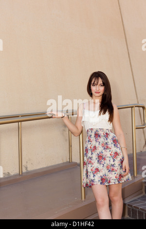Pretty woman standing on steps Stock Photo - Alamy