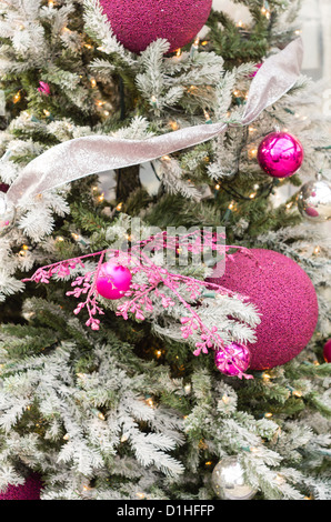 Decorated Christmas tree with ornaments and pine cones against a ...