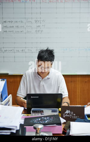 Manager in front of the office desk with networking concept Stock Photo ...