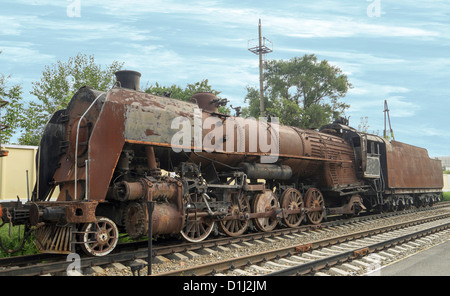 Old broken down steam train engine and tender being restored in a ...