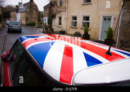 Mini cooper car with union flag on roof and side mirrors, hung on wall ...