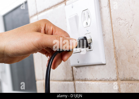 Hand Plugging Power Cord into Wall Outlet - Electrical Stock Photo ...