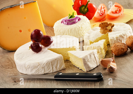 Different sorts of cheese on a wooden board Stock Photo - Alamy