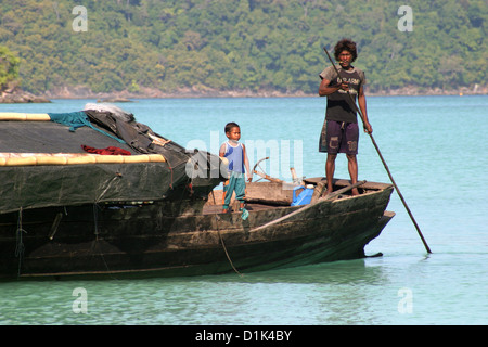 A Moken boy, sea gypsies of the Andaman sea on his boat house, kabang ...