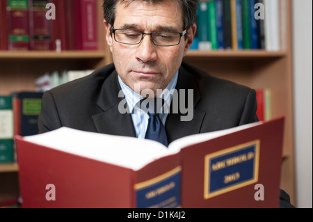 Environmental corporate portrait of solicitor, lawyer, attorney reading ...