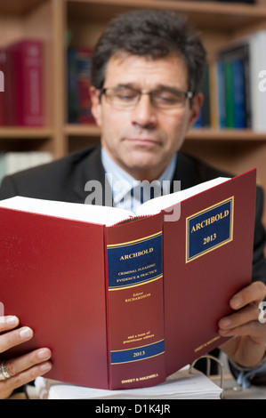 Environmental corporate portrait of solicitor, lawyer, attorney reading ...