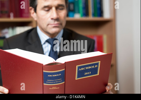 Environmental corporate portrait of solicitor, lawyer, attorney reading ...