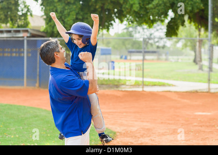 Hispanic boys on baseball field Stock Photo - Alamy