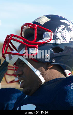 Corey Cooper, wide receiver for the East Coast Team, stiff arms a ...