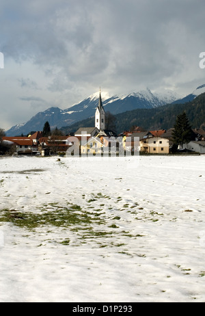 Alpine village scene, church steeple, houses, mountain, green trees ...