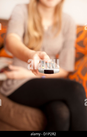 Woman pointing remote control Stock Photo - Alamy