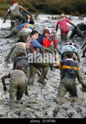 Competitors struggle through the mud on the 7 mile course through the ...