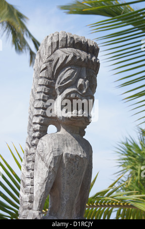 A carved wooden statue of the Hawaiian god Ku centers the banyan canyon ...