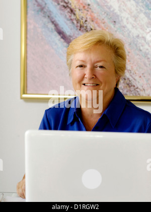 Portrait of smiling mature woman behind windowpane Stock Photo - Alamy