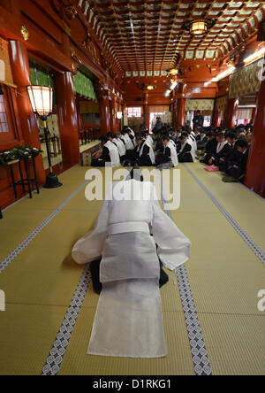 A Shinto priest performs a purification ritual by waiving a harai-gushi ...