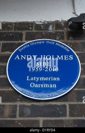 A blue plaque commemorating Andy Holmes MBE, on a boathouse in Upper ...