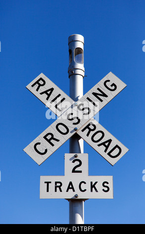 Two tracks railroad crossing sign beside a railway. Two tracks railroad ...
