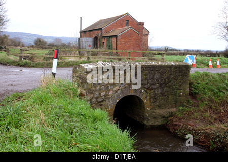Very old and cracked bridge over a drainage ditch, known as a rhyne on ...