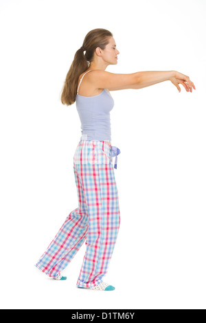 young sleepwalking woman in pajamas isolated on white background Stock ...
