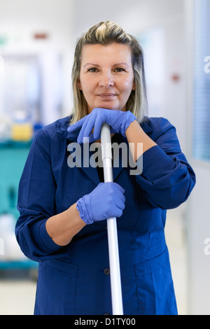 Woman cleaning office with mop Stock Photo - Alamy