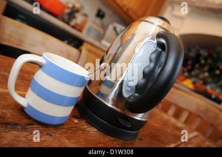 A blue and white stripped Cornish Ware mug sitting on a table Stock ...
