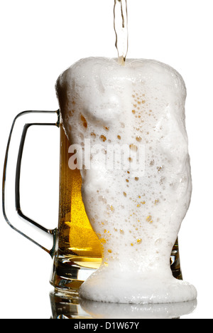 Beer foam overflowing from glass pint, isolated on black background ...