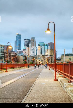 Night time at the Stone Arch Bridge in Minneapolis with the skyline at ...