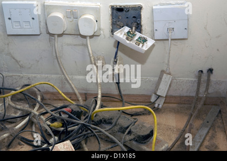 dusty power cables and electrical plugs in a British household Stock ...