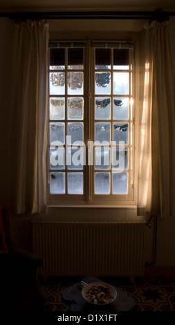 Winter sunlight shining through window in cottage Stock Photo - Alamy