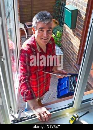 smiling man working with window Stock Photo - Alamy