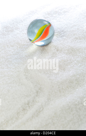 Playing with marbles on sand Stock Photo - Alamy