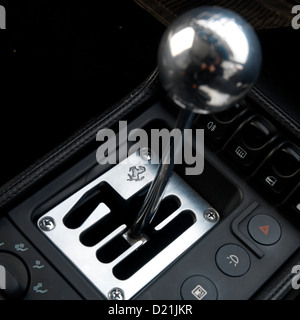 The driver controls the gear lever of manual transmission in the car ...