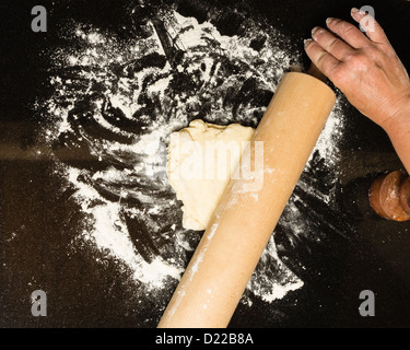 A baker rolling out dough for biscuits Stock Photo - Alamy