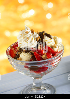 ice cream sundae in chocolate glaze in a plate on a blue background ...