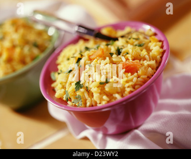 Grains of rice in bowls on table on sackcloth background Stock Photo ...