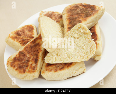 Scottish girdle scones (or griddle scones) cooking in a heavy-bottomed ...