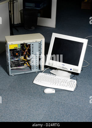 Computer with keyboard and mouse by CPU on wooden table against wall ...