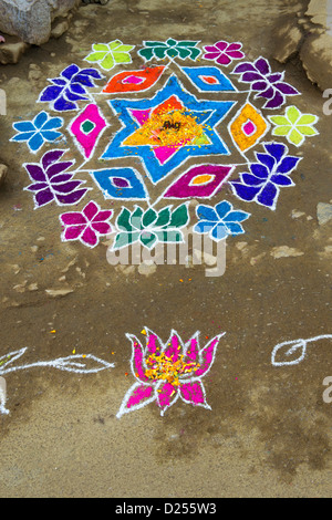 Rangoli design with flowers and cow dung used in an Indian street to ...