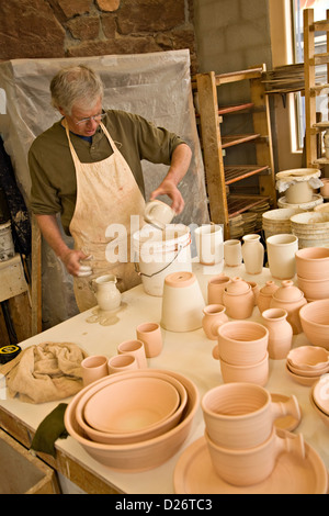 Adult man glazing pottery Stock Photo - Alamy