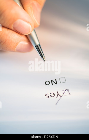 Vertical shot of the hand of a male filling liquid from a bottle into a ...