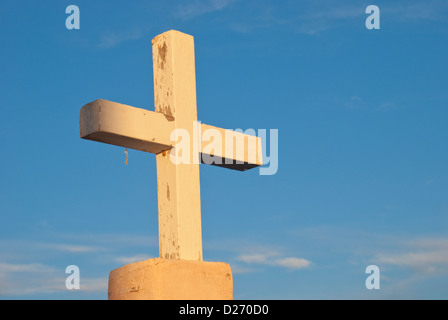Evening sun lights up a cross in the churchyard at the old Santa Rosa ...