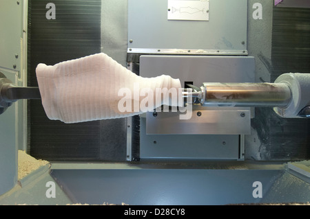 A shoe Last (foot shaped forms used to make shoes) is carved by a 3d ...