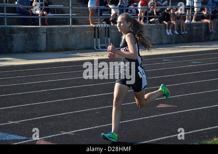 High school female teen runner is exhausted after running a long ...