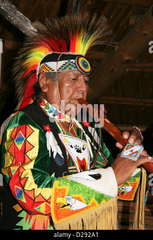 Shuswap Cultural Guide Playing Indian Flute Inside Pit House At ...