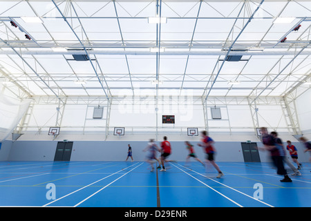 children palying basketball inside school sports hall Stock Photo - Alamy