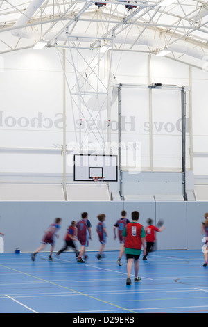 children palying basketball inside school sports hall Stock Photo - Alamy