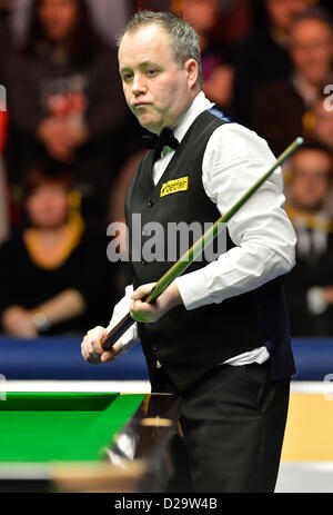 John Higgins in action against Judd Trump (not pictured) on day seven ...