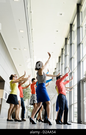 African american office worker dancing surrounded by coworkers. Happy ...