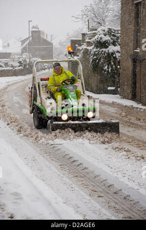 Small snow plough clearing the sidewalk, private company contracted by ...